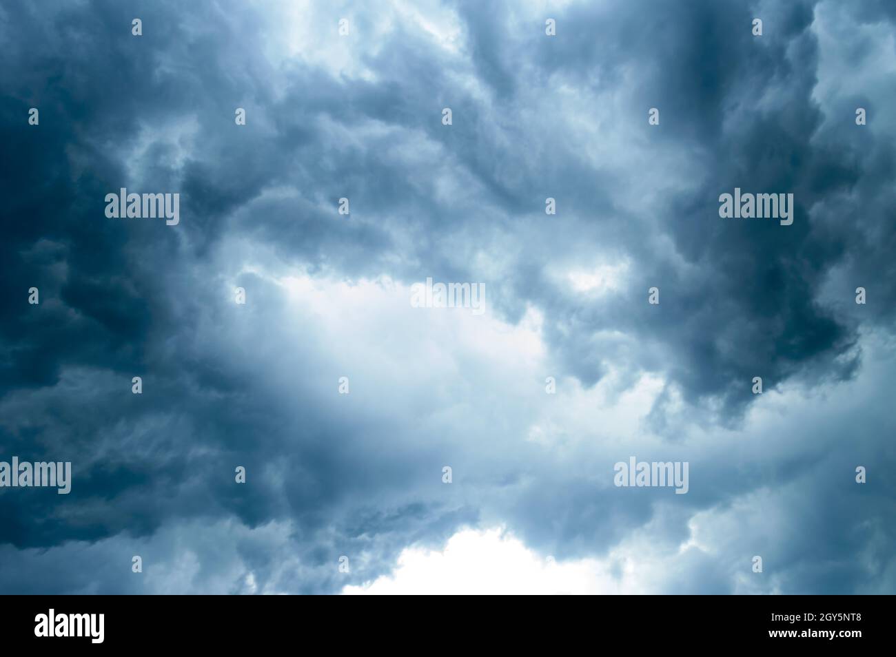 Thick dark black storm clouds covering summer sunset sky with gale ...
