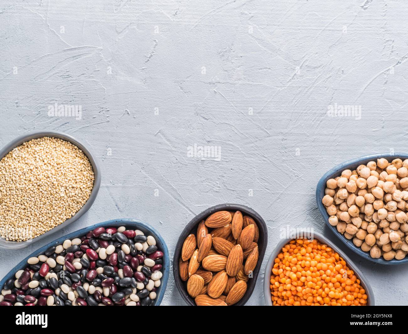 Vegetarian healthy protein sources on gray concrete background. Quinoa ...