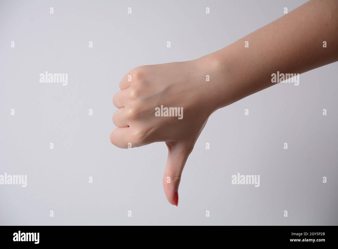 Hand thumb down isolated on the left side on white background ...