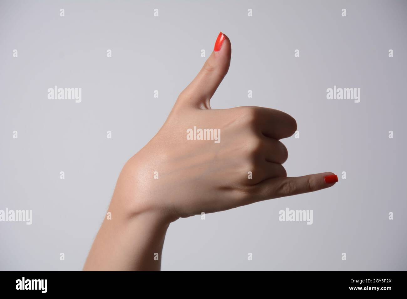 Woman's hand shows a sign to make a phone call. Close up. High ...