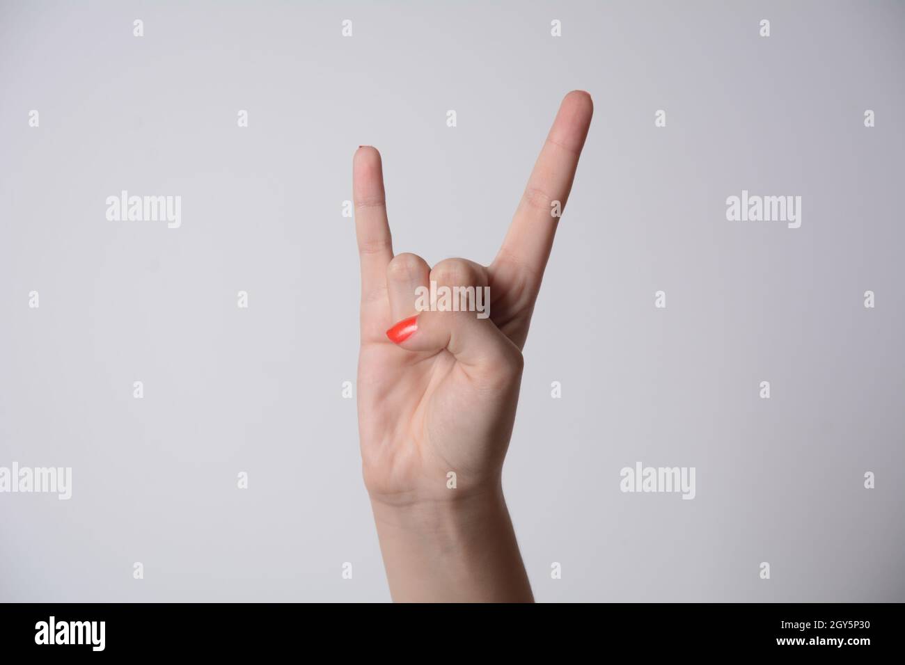 Woman hand showing devil horns gesture. Winning and triumph sign ...