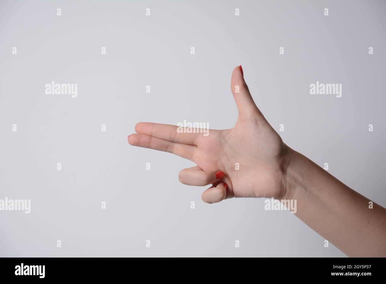 Girl's hand making shooting gun, gesture. hand pistol gesture on ...