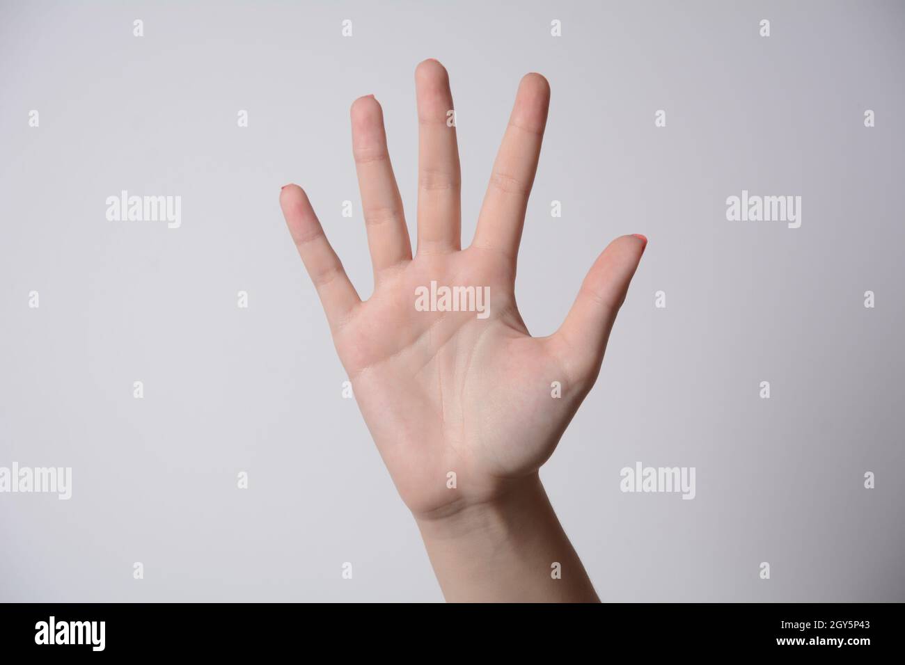 Female hand extended in greeting isolated on white. Number five Stock ...