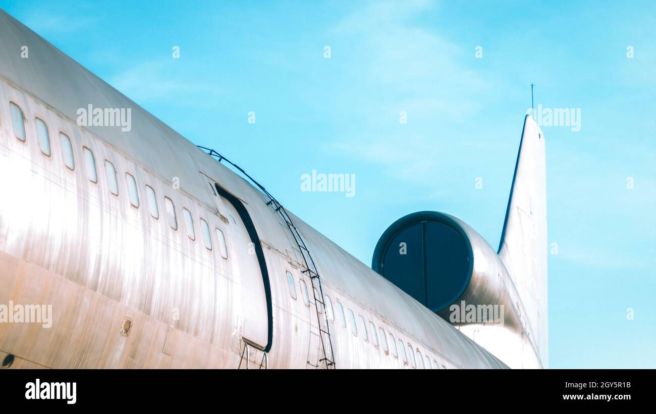 airplane exit door and window close up against blue sky Stock Photo - Alamy