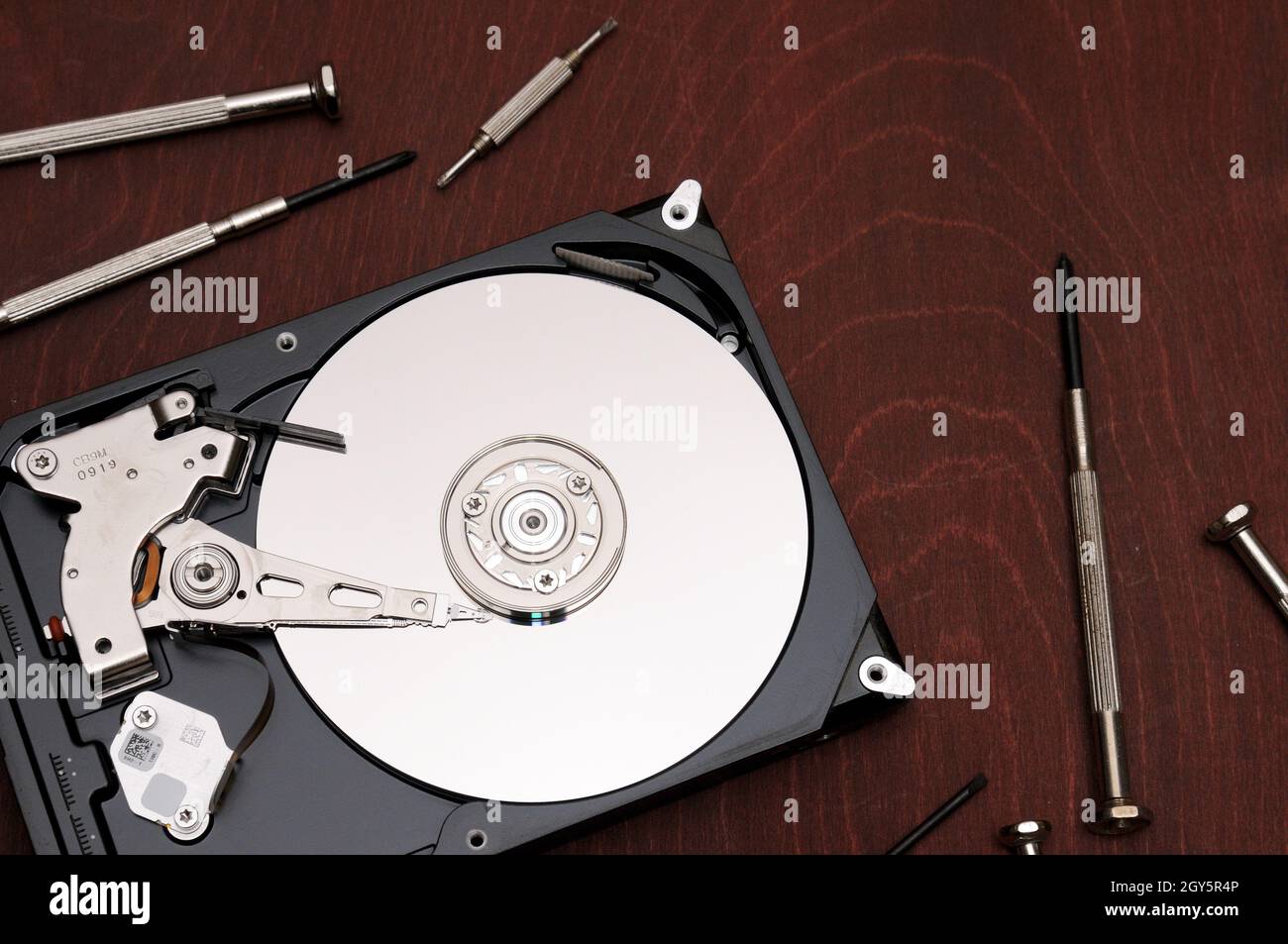 Internal parts of a hard disk on an isolated braun,wood background ...