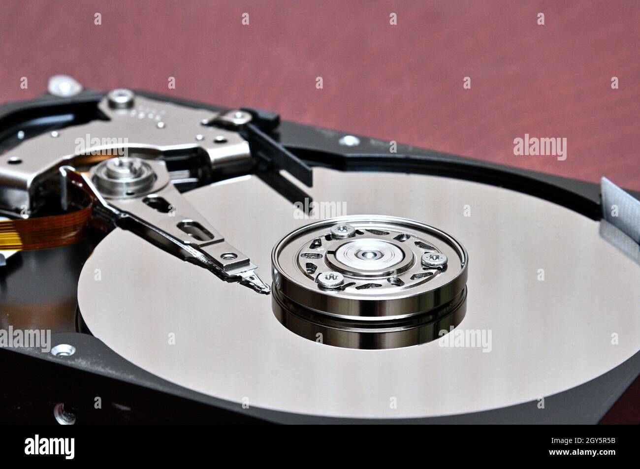 Internal parts of a hard disk on an isolated braun,wood background ...