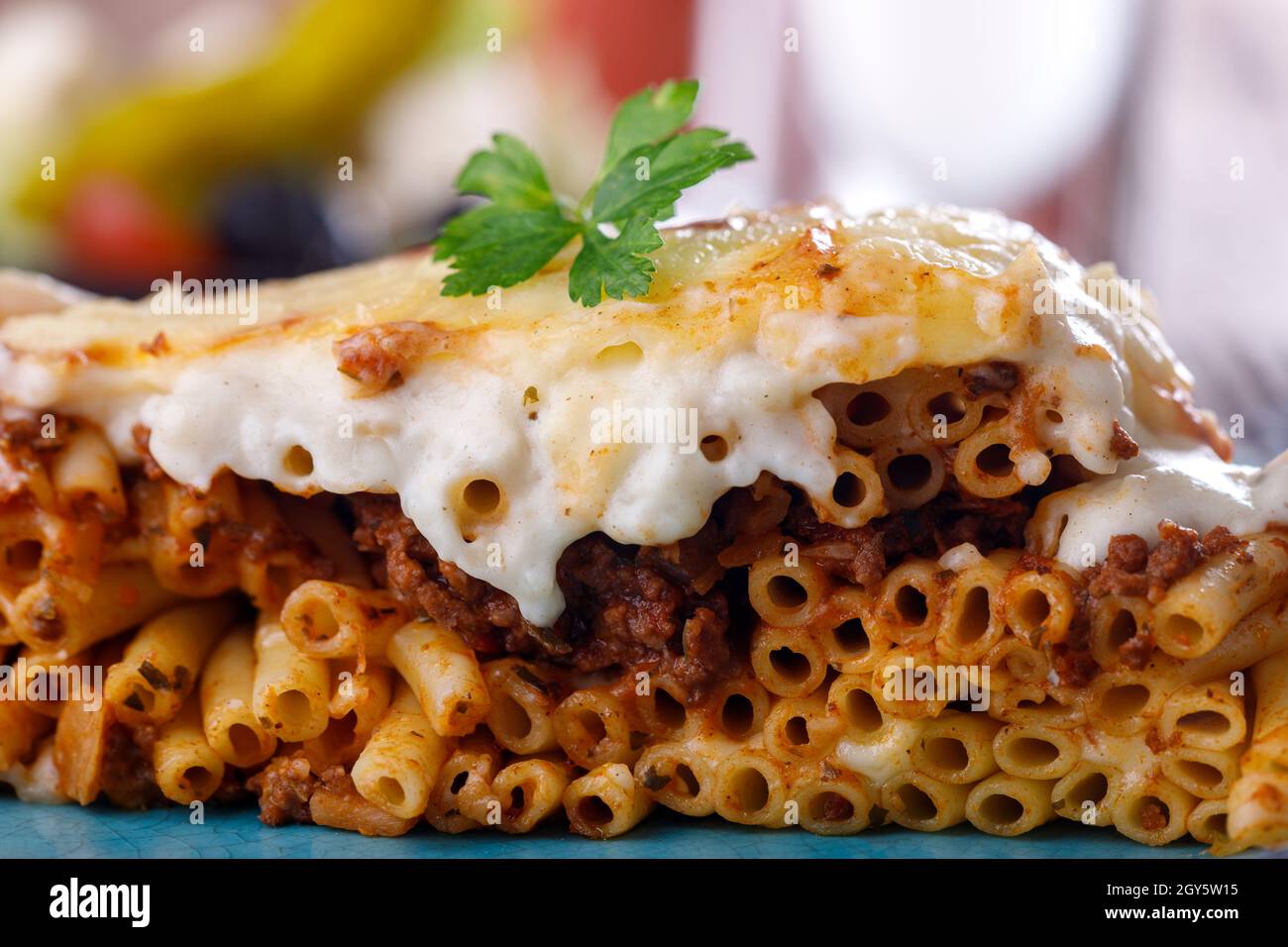 greek Pastitsio dish on a blue plate Stock Photo - Alamy