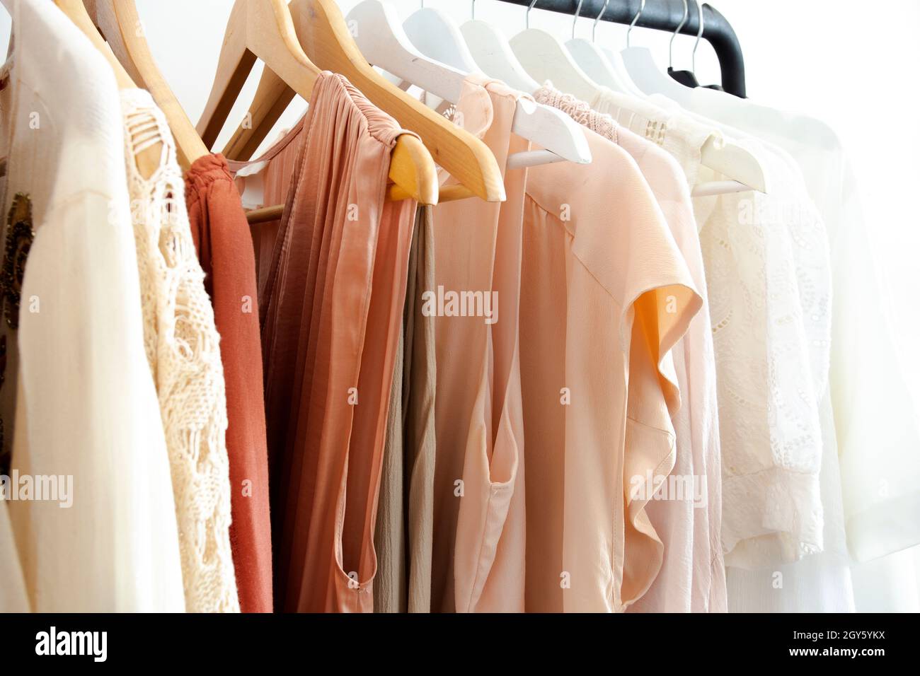 Stylish womans clothes hanging on a rack natural colors, trending ...