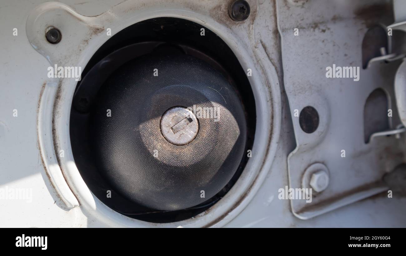 Fuel cap of a white sports car. Close the gas tank cap. The fuel tank ...