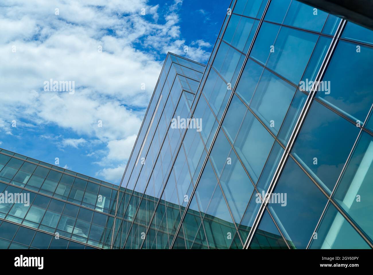 Low angle view of modern glass office building abstract background ...