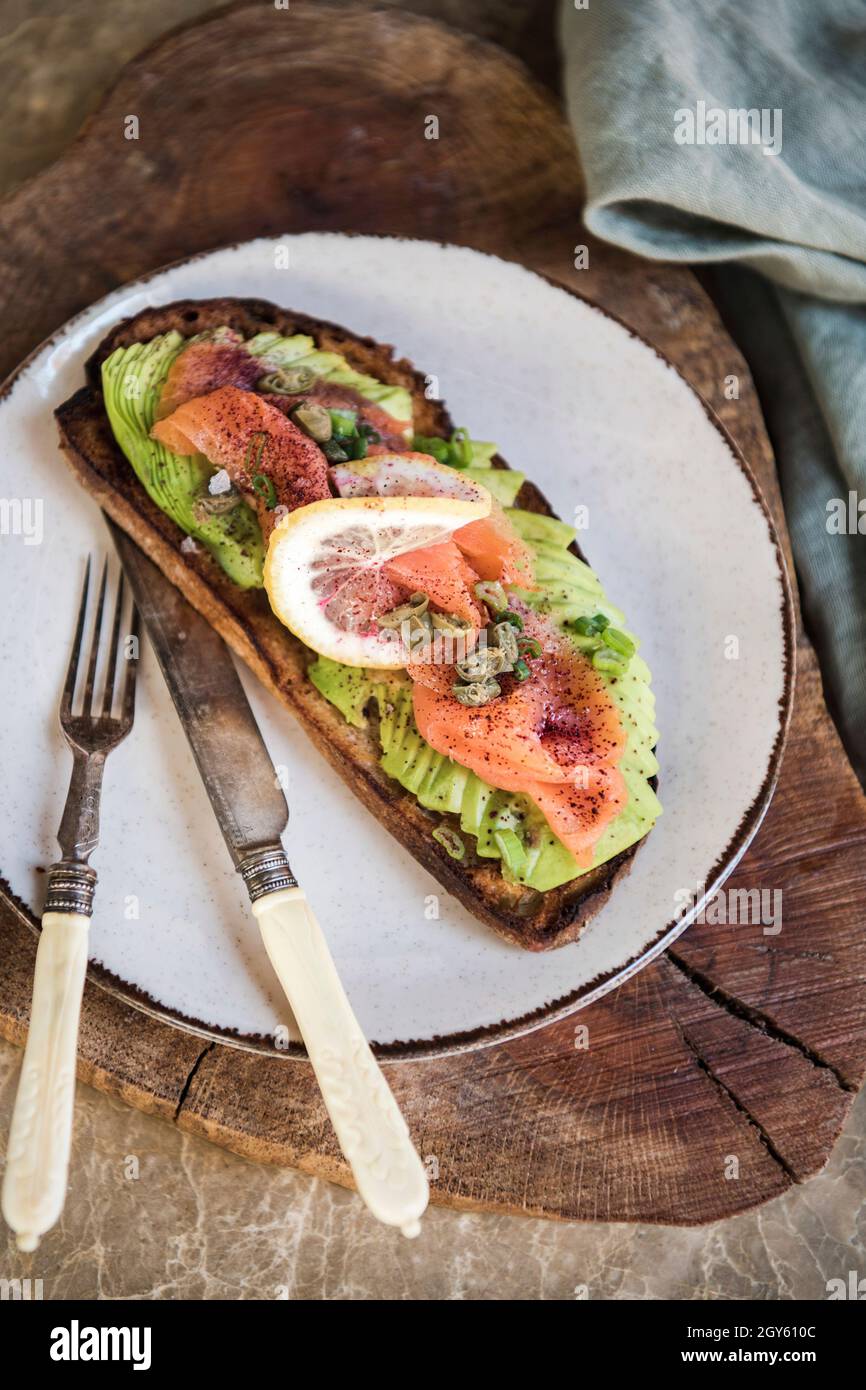 Flat-lay of healthy sourdough avocado toast with smoked salmon in white ...