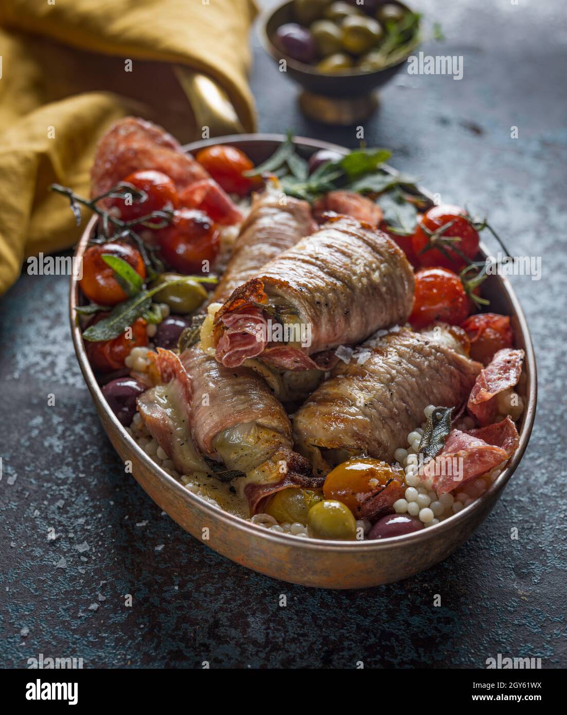 Pork Involtini served in a pan with roasted vegetables Stock Photo - Alamy