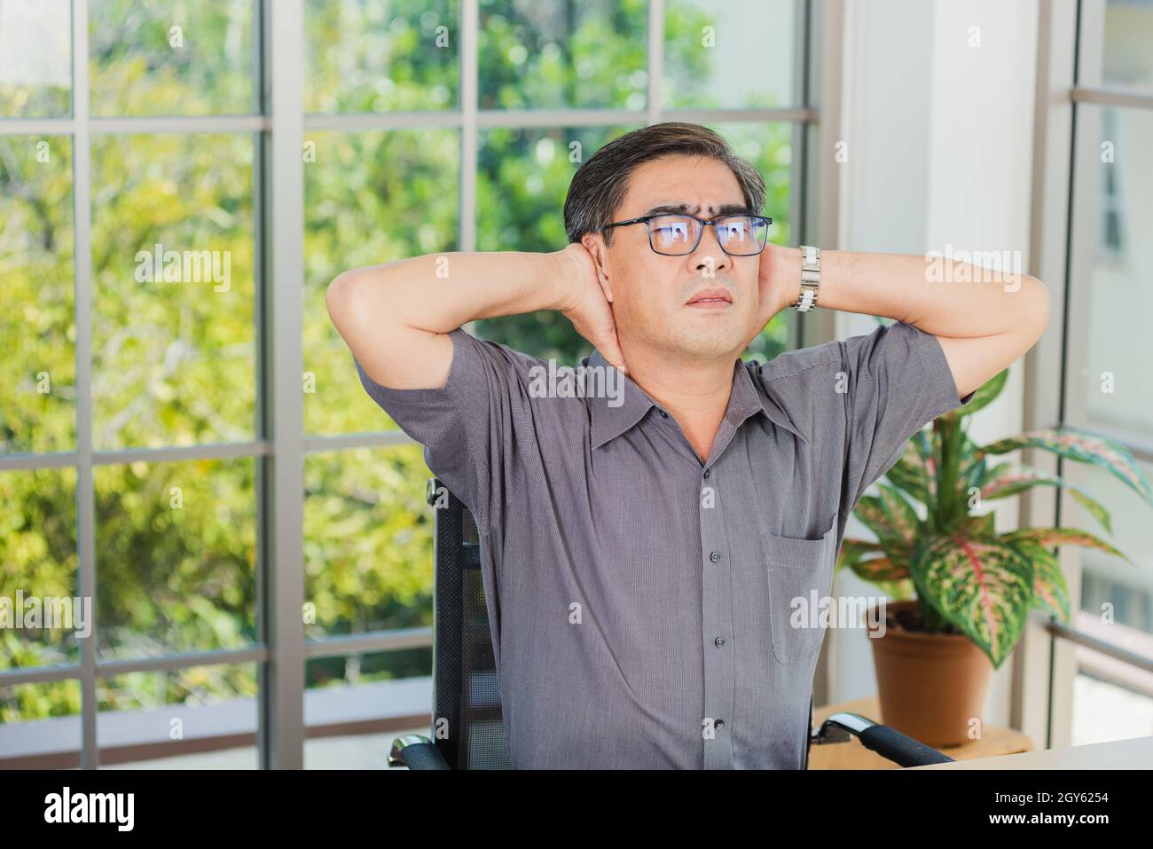 Asian hard senior businessman working with laptop computer has a ...