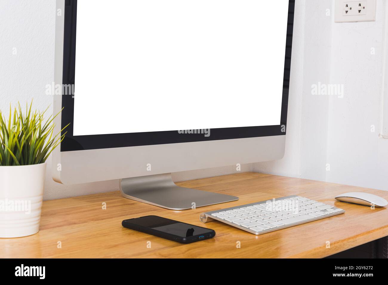 Computer monitor with white blank screen on the business desk with ...