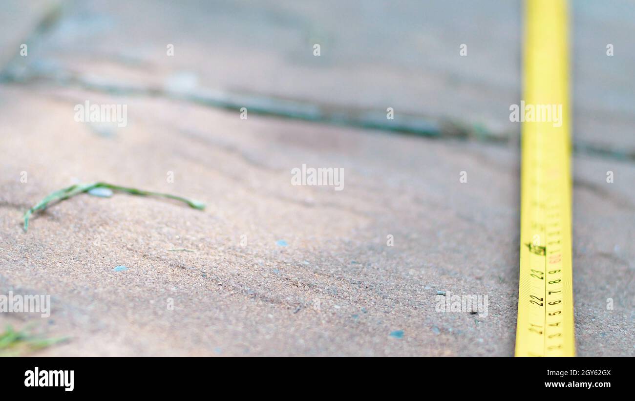 Tape measure road. Men's hands hold a measuring tape. Construction ...