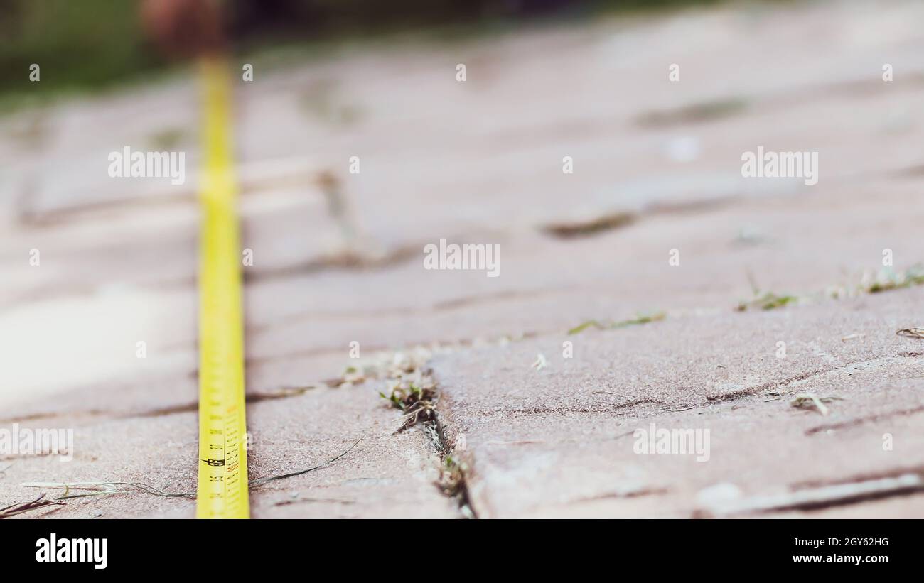 Tape measure road. Men's hands hold a measuring tape. Construction ...