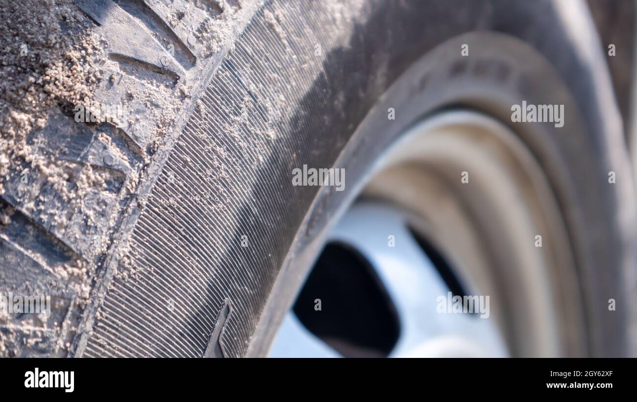 Dirty car wheel on a soil road to the countryside. Close-up detail of a ...