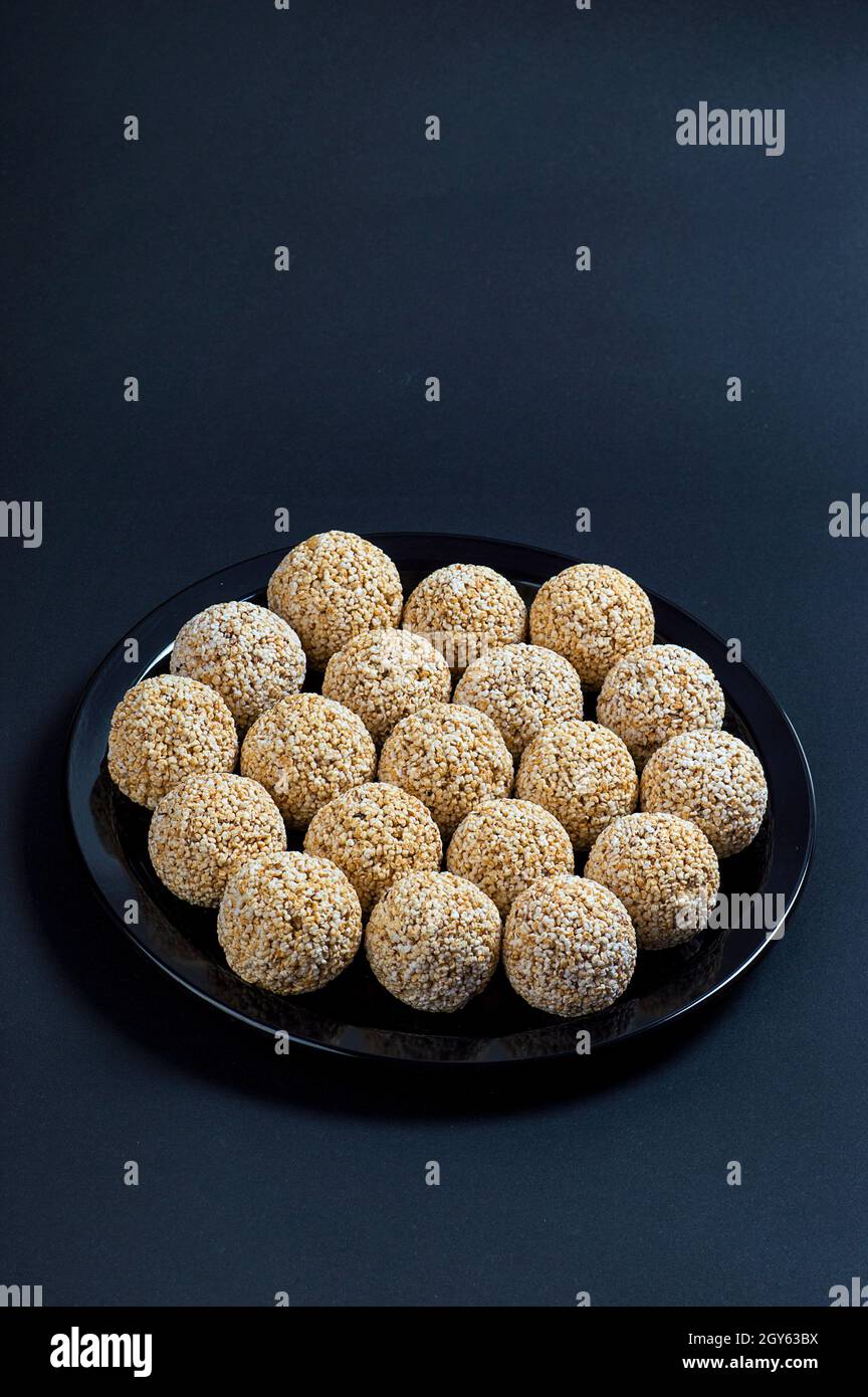 Amaranth ladoo or Rajgira laddu or Cholai ke laddo in black plate on ...