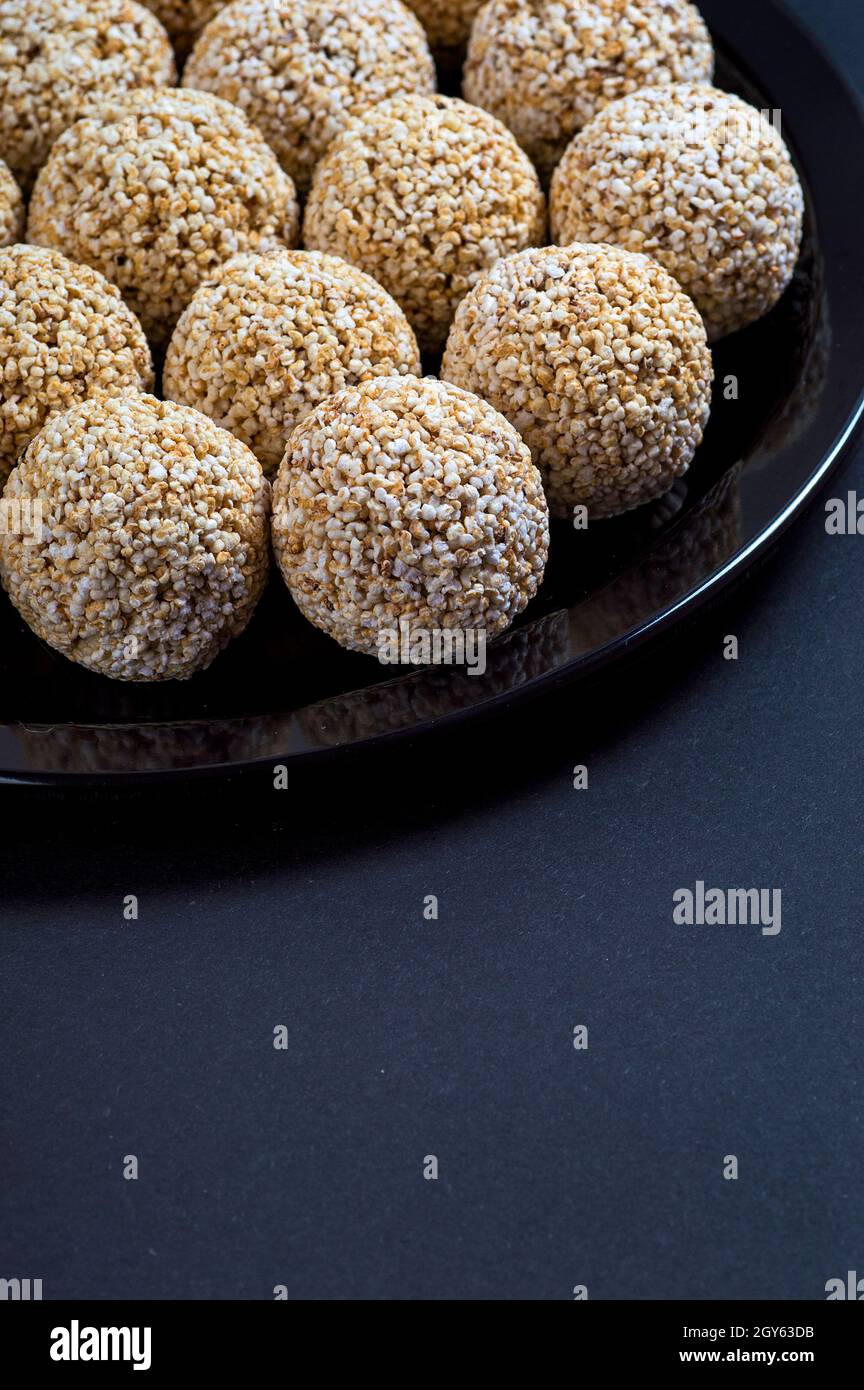 Amaranth ladoo or Rajgira laddu or Cholai ke laddo in black plate on ...