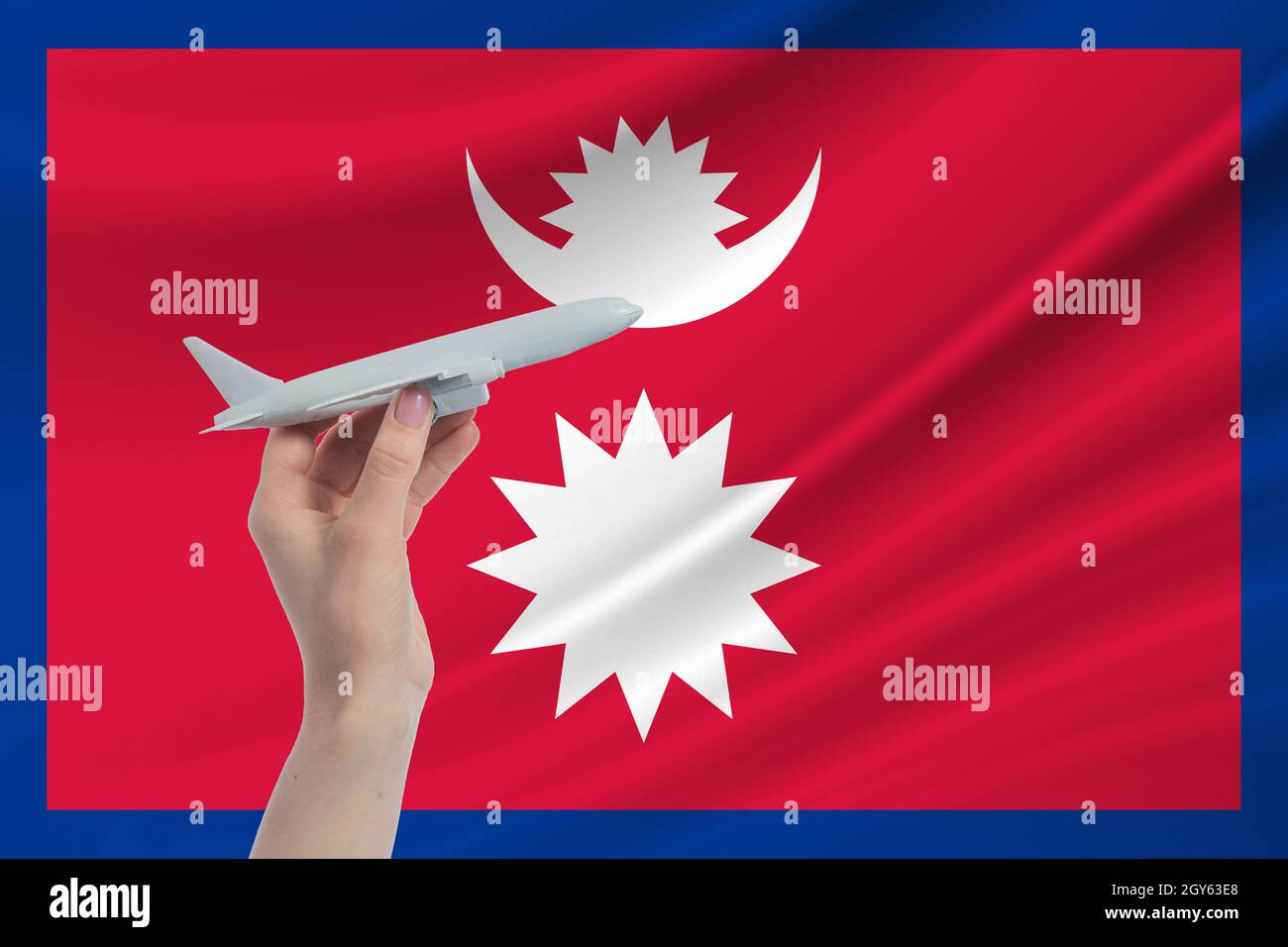 Airplane in hand with national flag of Nepal. Travel to Nepal Stock ...