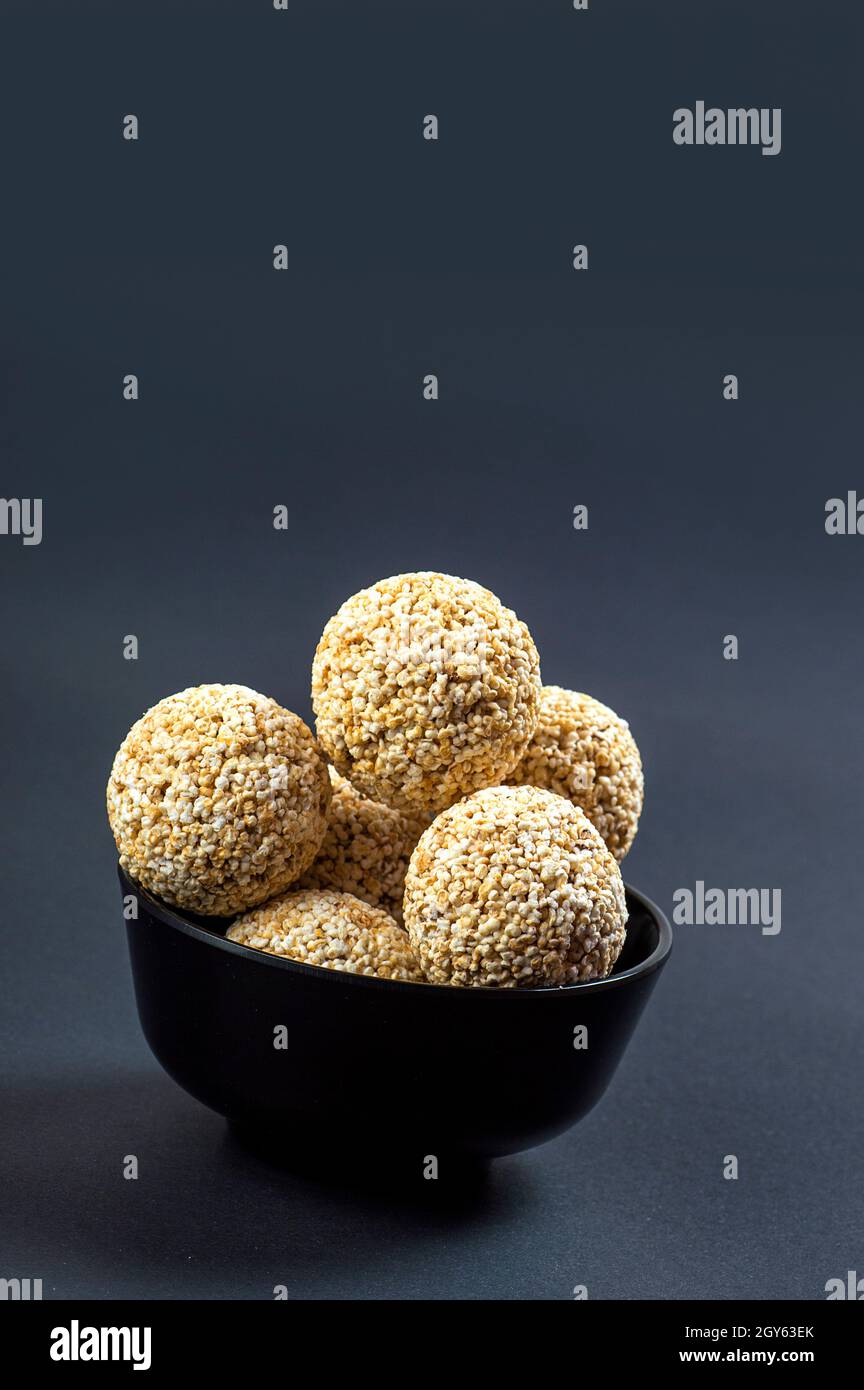 Amaranth or Rajgira laddu, Cholai ke laddo in black Bowl on black ...