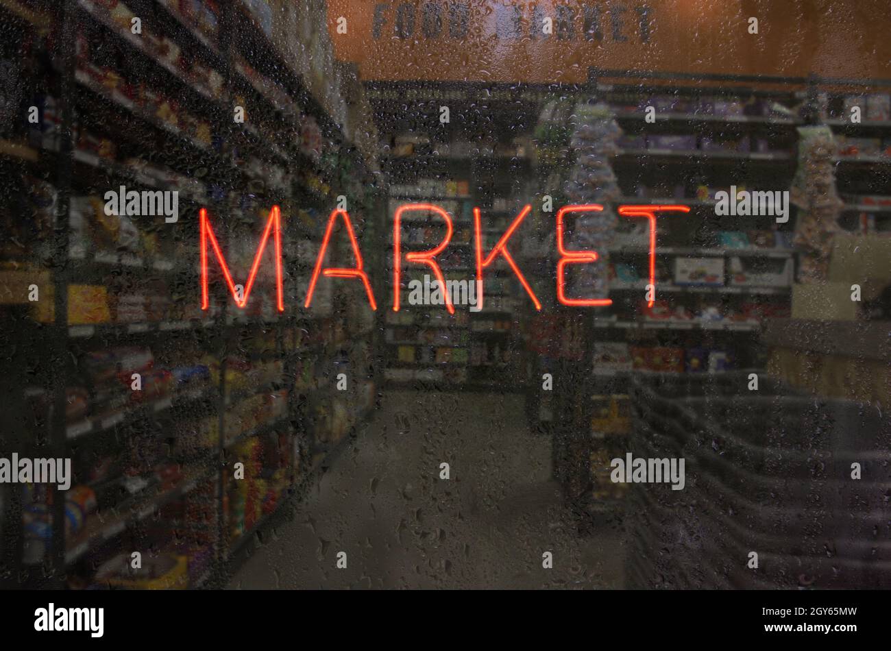 Neon Market Sign in Wet Window With Blurred Market in Background Stock ...