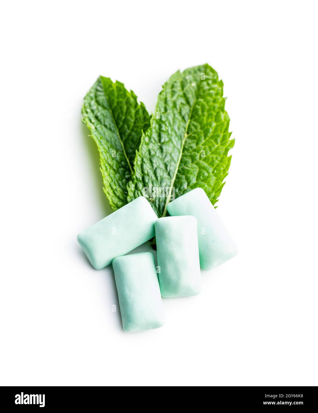 Mint chewing gum pads and green mint leaves isolated on white ...