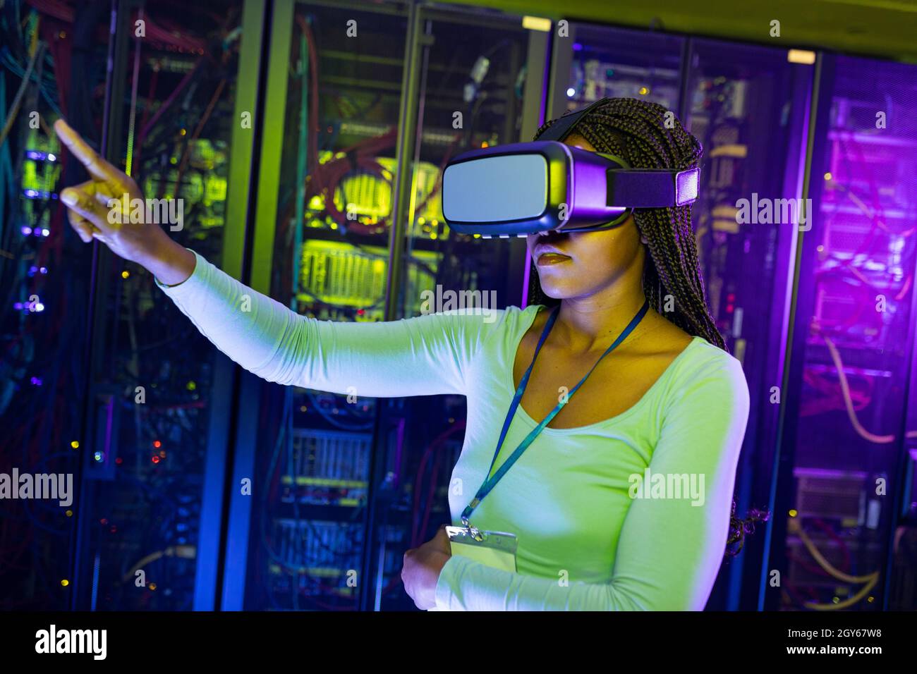 African american female computer technician wearing vr headset and ...
