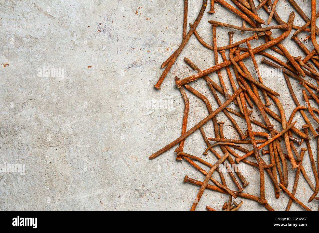 Rusty used nails on a cement metal background Stock Photo - Alamy