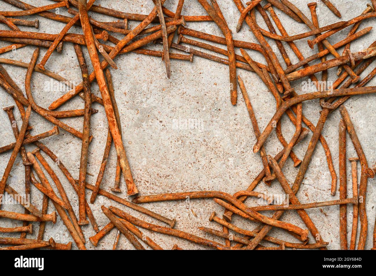 Rusty used nails on a cement metal background Stock Photo - Alamy