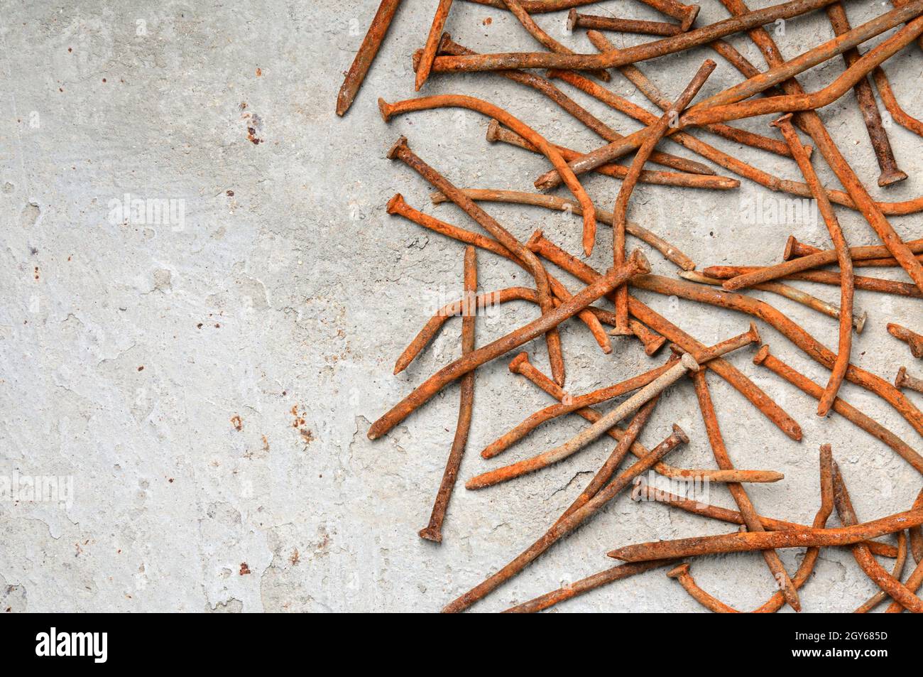 Rusty used nails on a cement metal background Stock Photo - Alamy