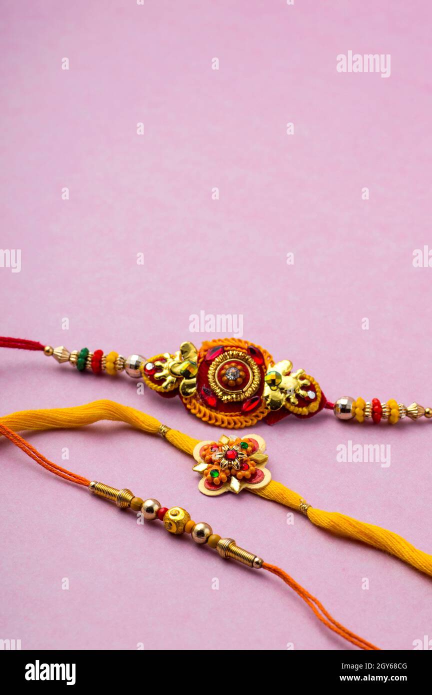 Raksha Bandhan background with an elegant Rakhi. A traditional Indian ...