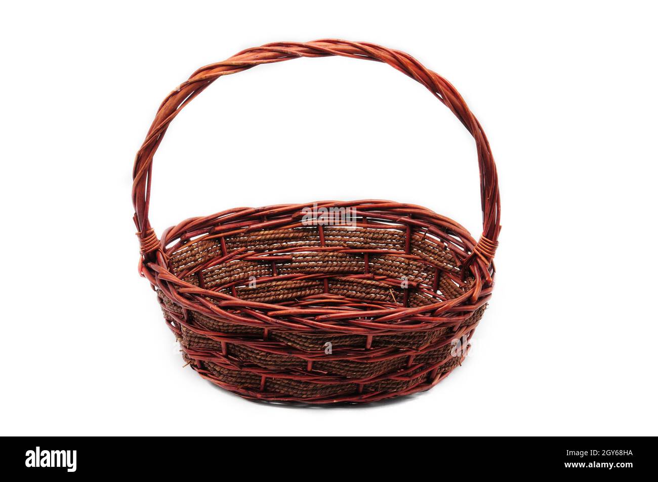 Straw basket on an isolated white background Stock Photo - Alamy