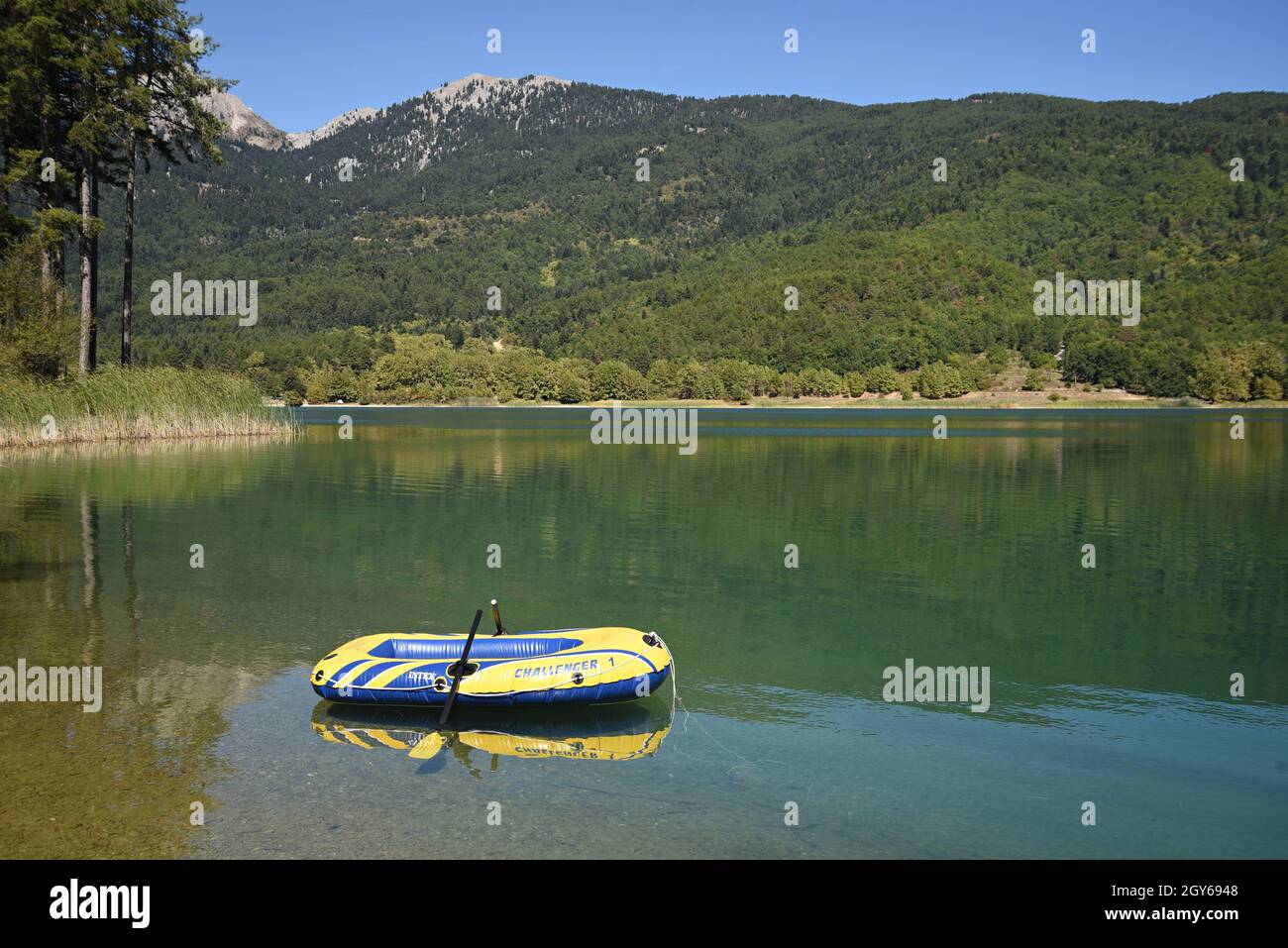 Landscape with scenic view of an inflatable raft lake dinghy boat on ...