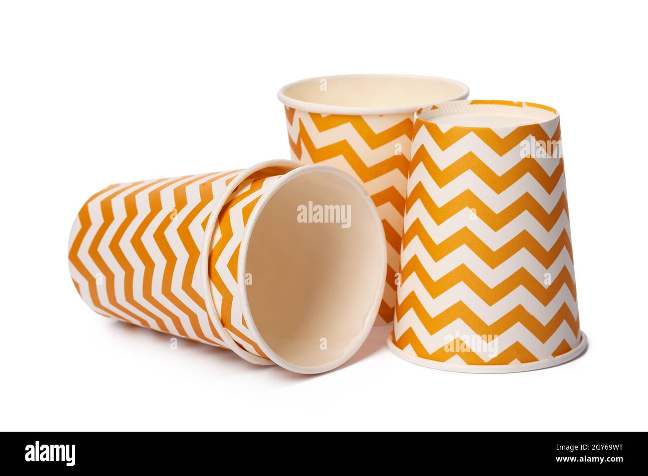 Pile of cardboard cups with beige geometric pattern isolated on white ...