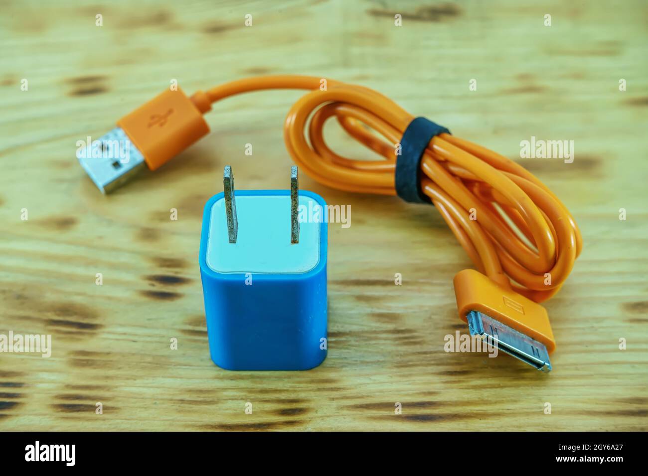 Electrical charging devices for mobile telephone on a wooden background ...