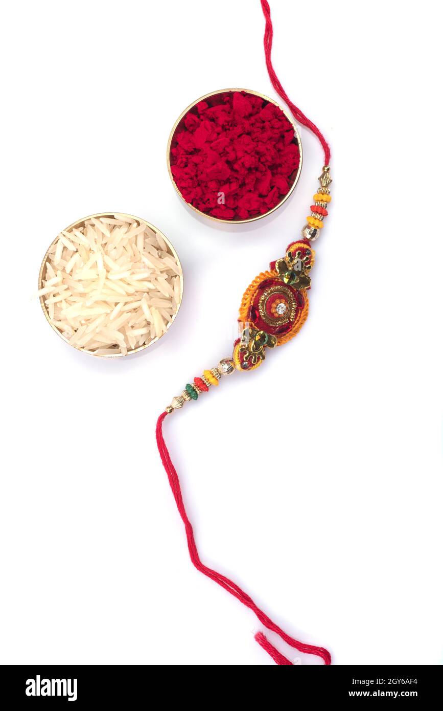 Indian festival: Raksha Bandhan background with an elegant Rakhi on a ...