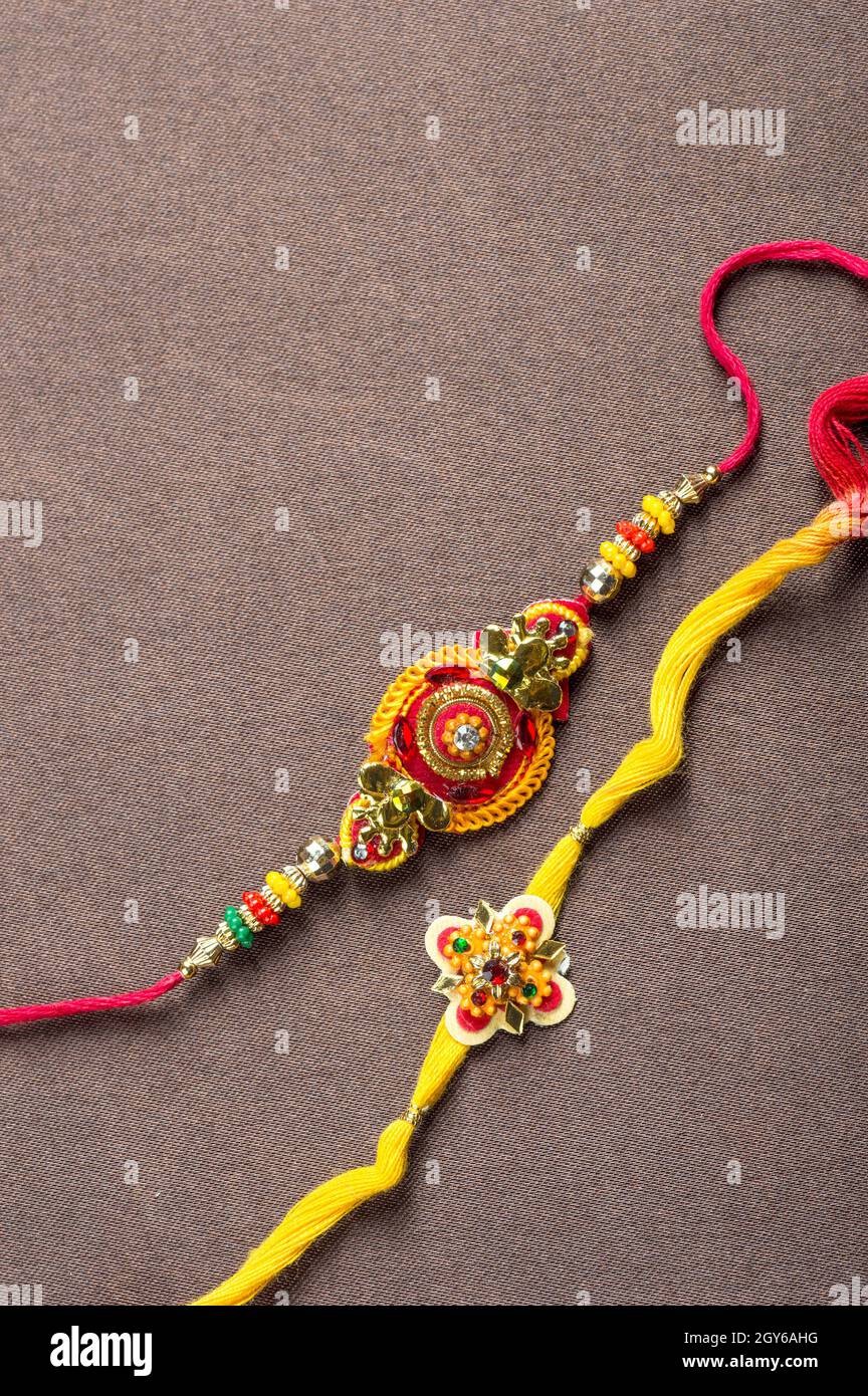 Raksha Bandhan background with an elegant Rakhi. A traditional Indian ...