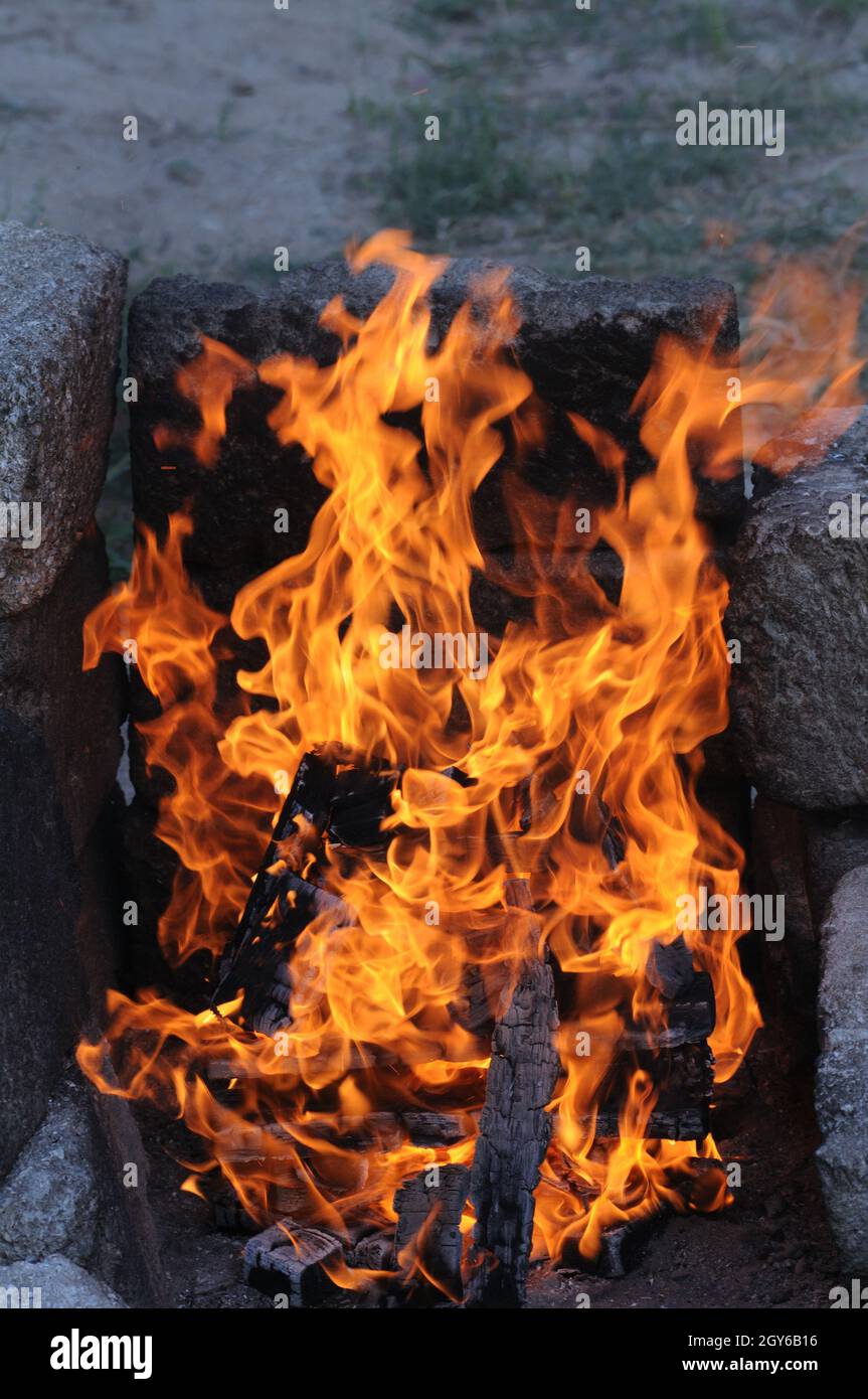 Campfire fire kindled in a camping trip Stock Photo - Alamy
