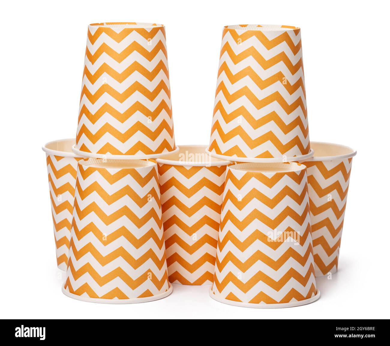Pile of cardboard cups with beige geometric pattern isolated on white ...