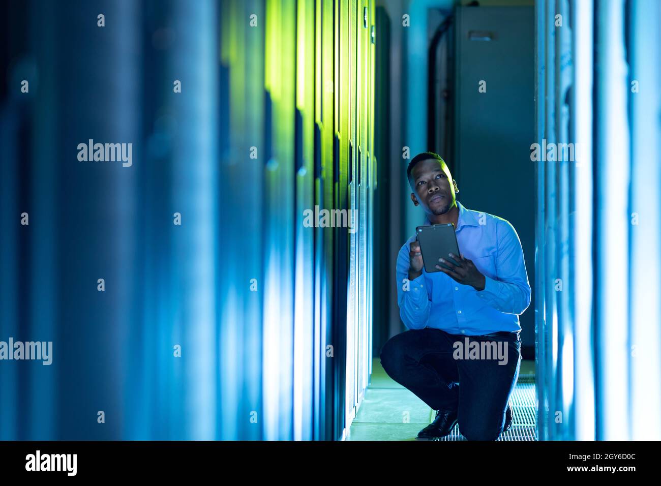 African american male computer technician using tablet working in ...
