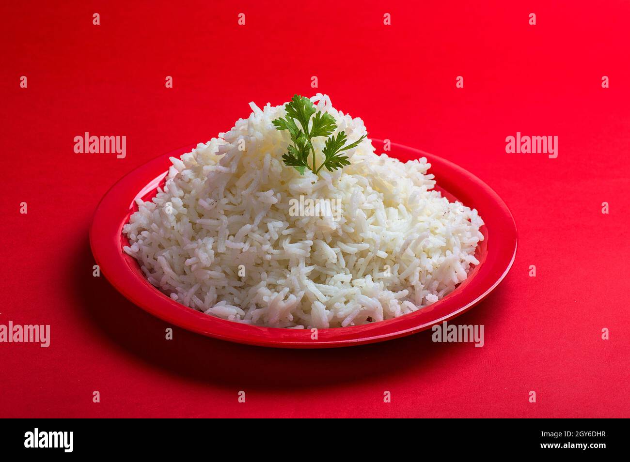 Cooked plain white basmati rice in a red plate on red background Stock ...