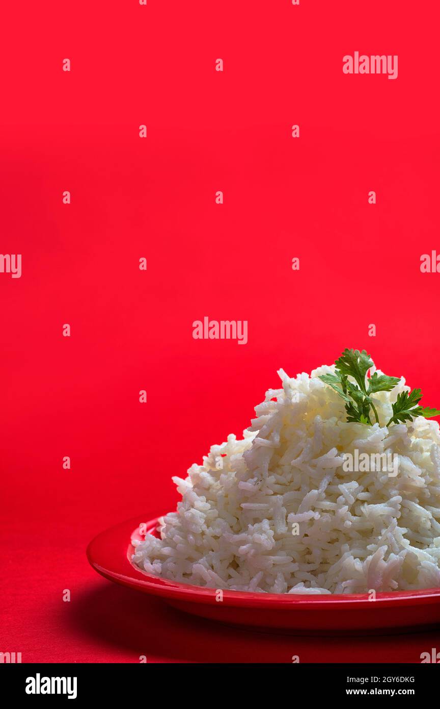 Cooked plain white basmati rice in a red plate on red background Stock ...