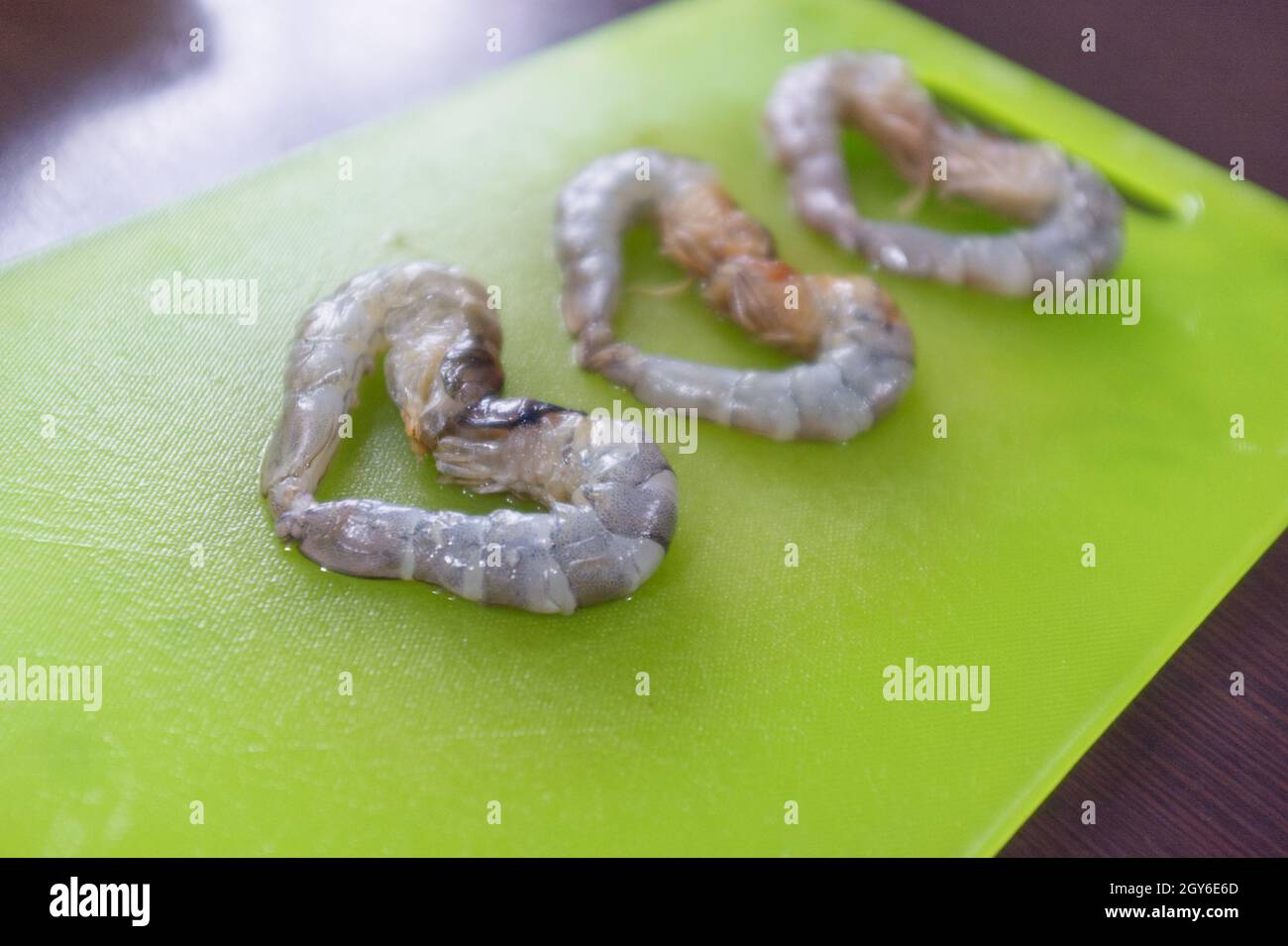 prawn in heart shape isolated on green background Stock Photo - Alamy