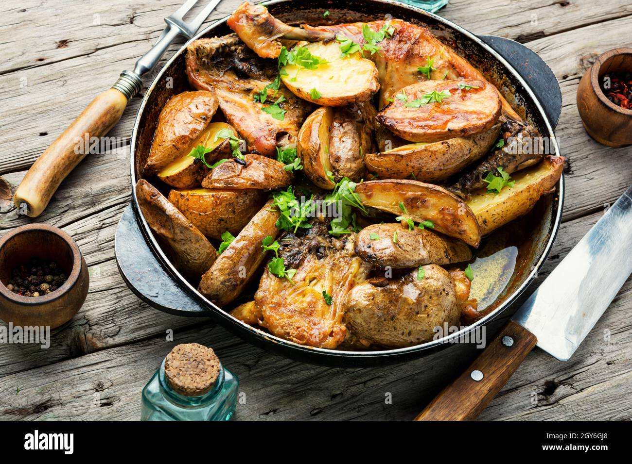 Appetizing chicken meat with potatoes roasted in a pan.Chicken pieces ...