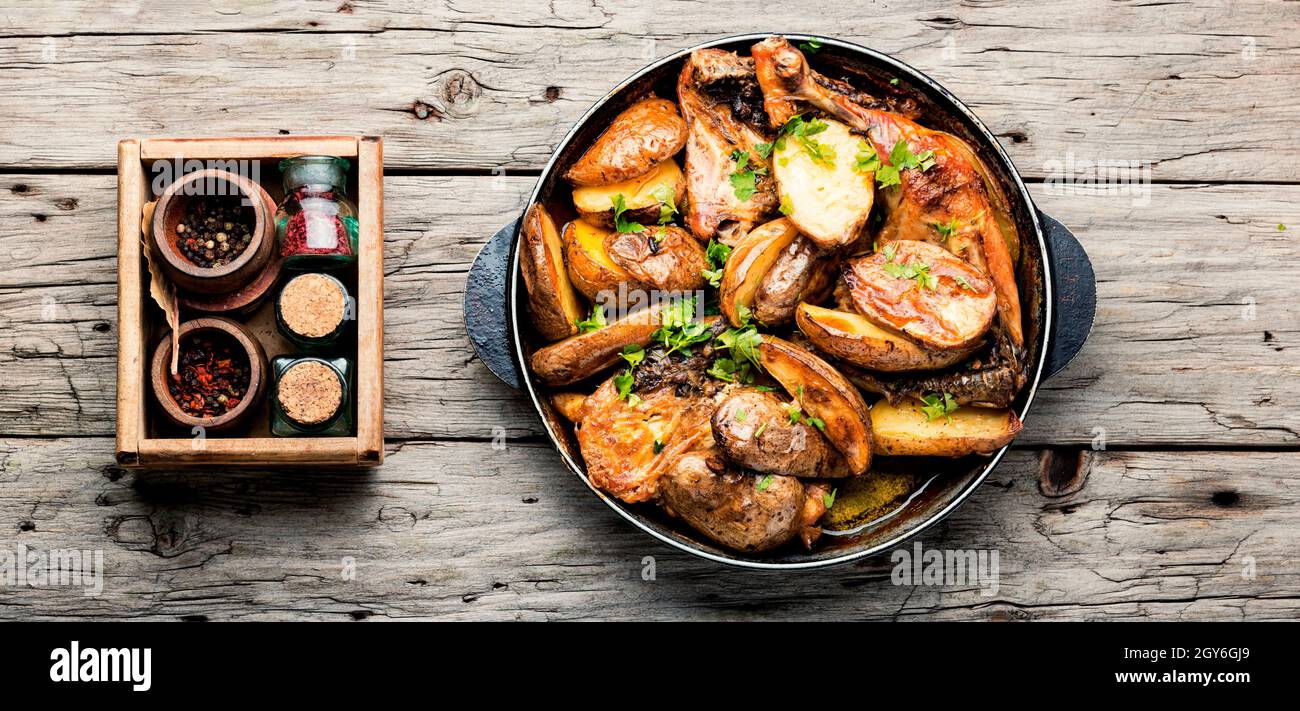 Appetizing chicken meat with potatoes roasted in a pan.Flat lay Stock ...