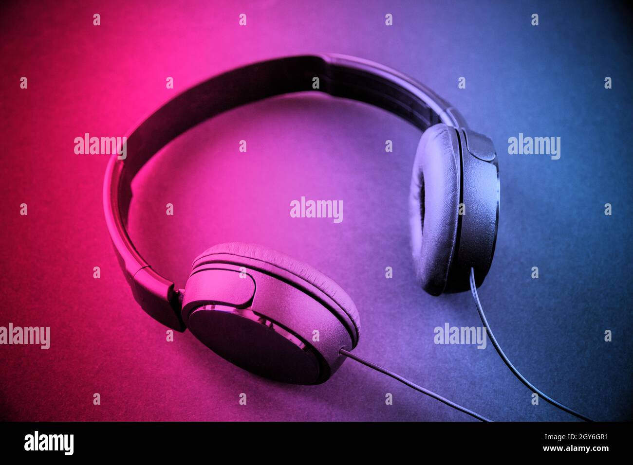Headphones isolated on a pink to blue gradient background Stock Photo ...