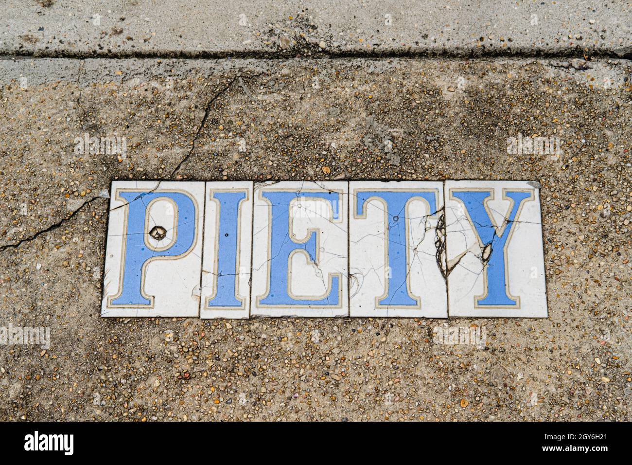 Traditional Piety Street tile inlay on sidewalk in Bywater neighborhood ...