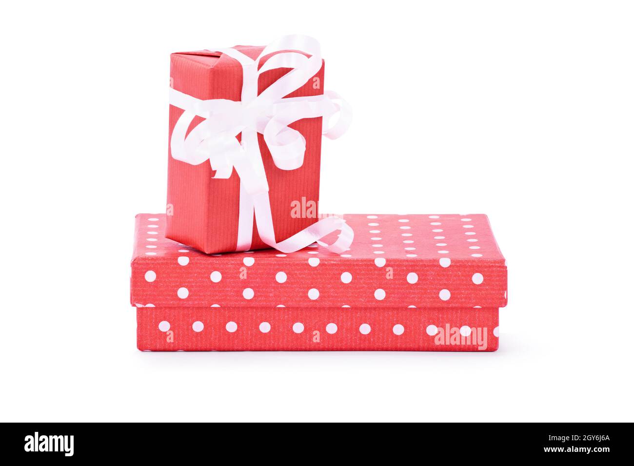 A gift box wrapped in red wrapping paper with white ribbon on top of a ...