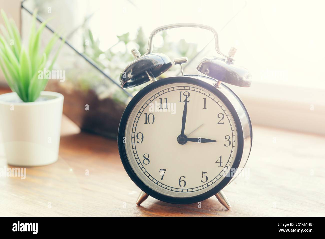 Morning sun. Alarm clock on a beautiful background Stock Photo - Alamy